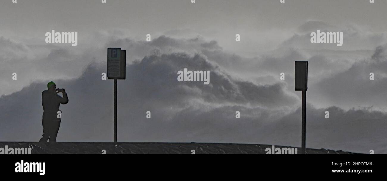 People watching high waves in Doolin in County Clare on the west coast ...