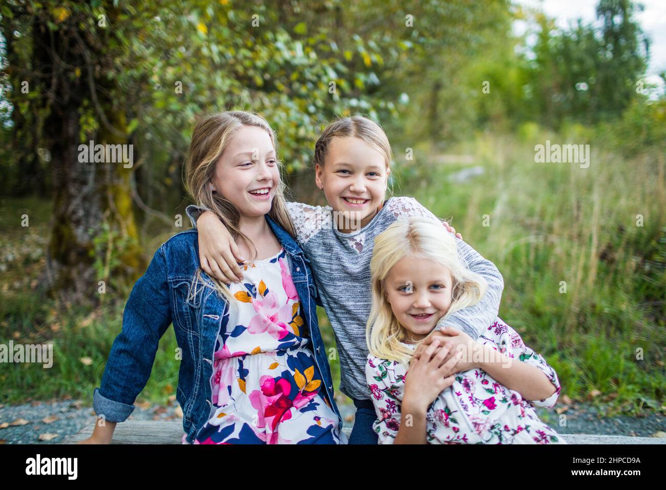 Three best friends laugh, hug and smile outside Stock Photo - Alamy