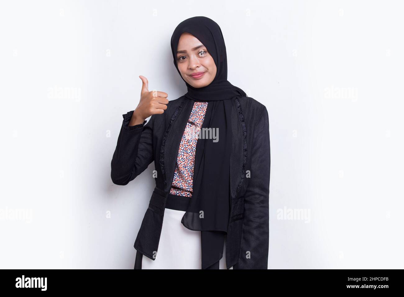 young asian beautiful muslim woman with ok sign gesture tumb up isolated on white background ...