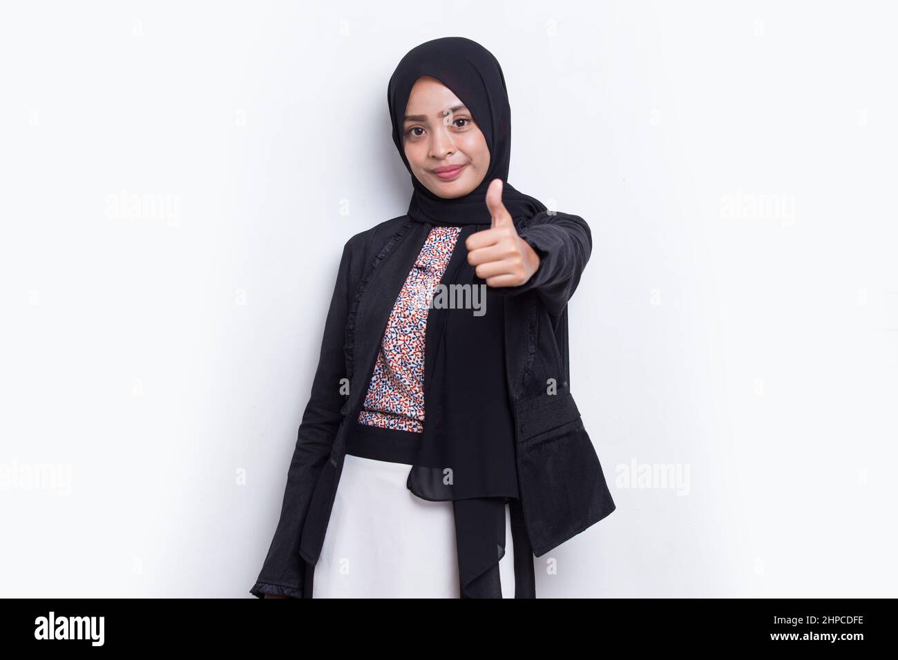 young asian beautiful muslim woman with ok sign gesture tumb up isolated on white background ...