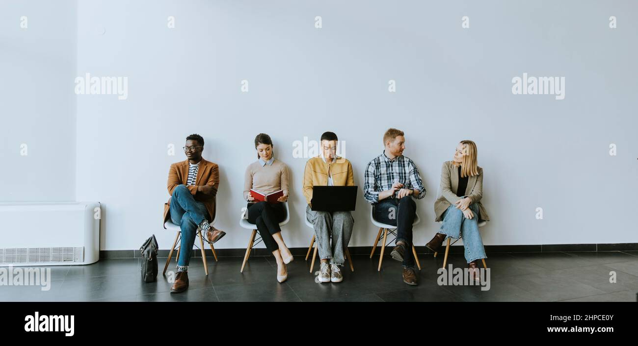 Group of bored young people waiting for the job interview Stock Photo ...