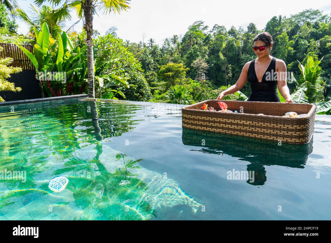 woman enjoying floating breakfast at luxury resort in Bali Stock Photo ...