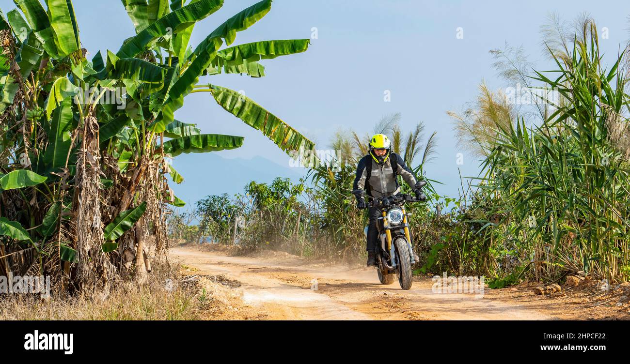 man riding his scrambler type motorcycle in north Thailand Stock Photo ...