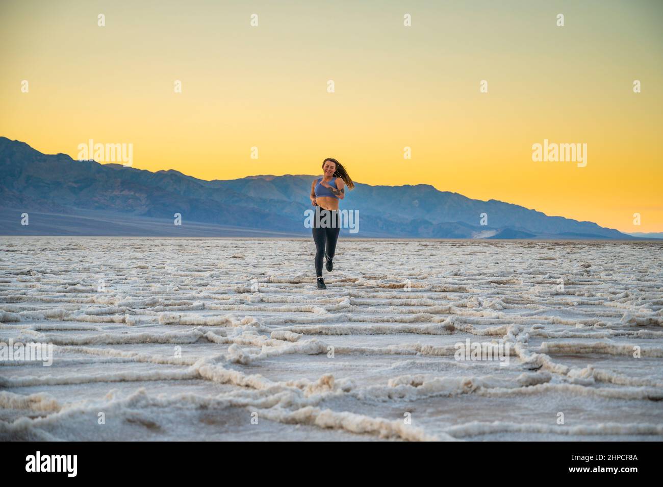 Female running at Badwater in Death Valley National Park Stock Photo ...