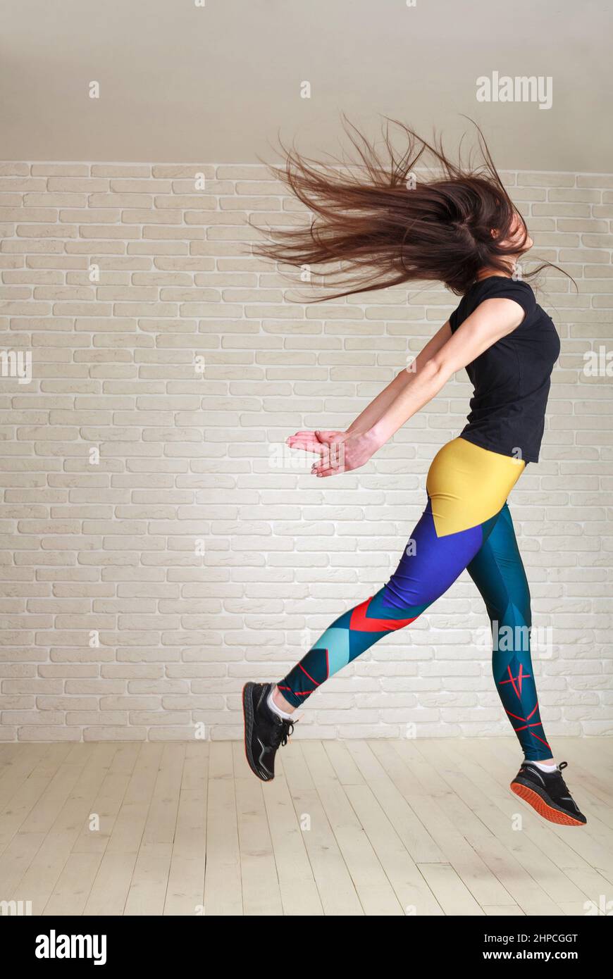 Active athletic slim young woman runner doing stretching exercises ...