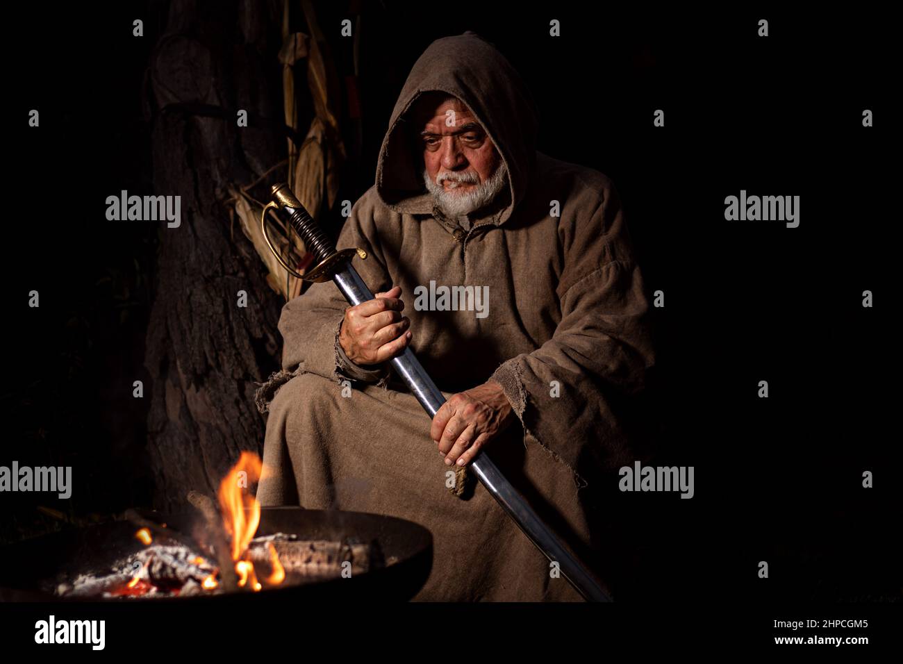 Templar with sword at the campfire Stock Photo - Alamy