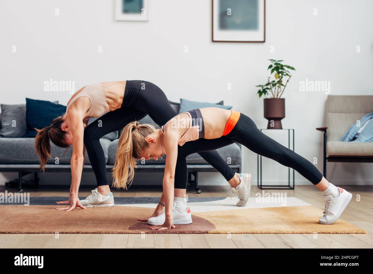 Mother and daughter working out at home, doing exercises Stock Photo ...