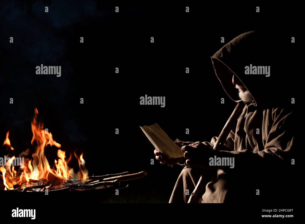 Old poor medieval man with message by the fire Stock Photo - Alamy
