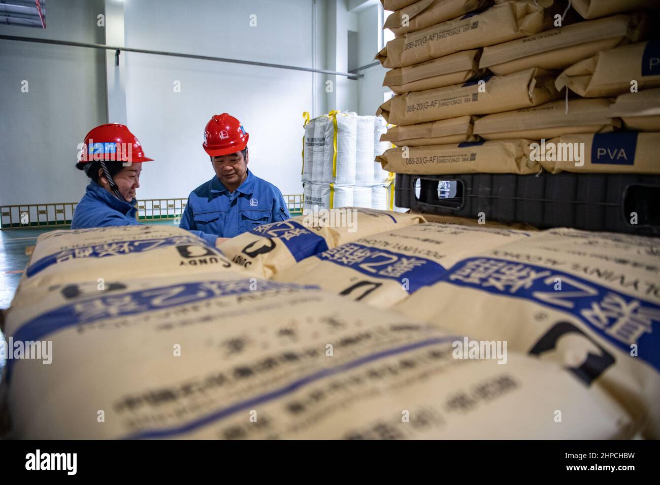 Chongqing, China. 12th Feb, 2022. Staff members check the packaging of ...