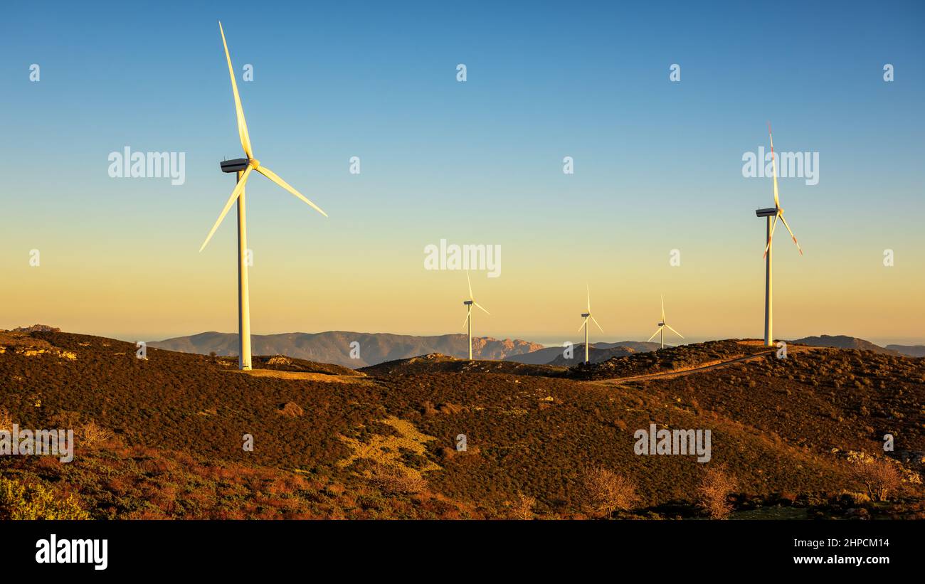 Wind turbines on a beautiful sunset sky in a mountain wind farm in ...