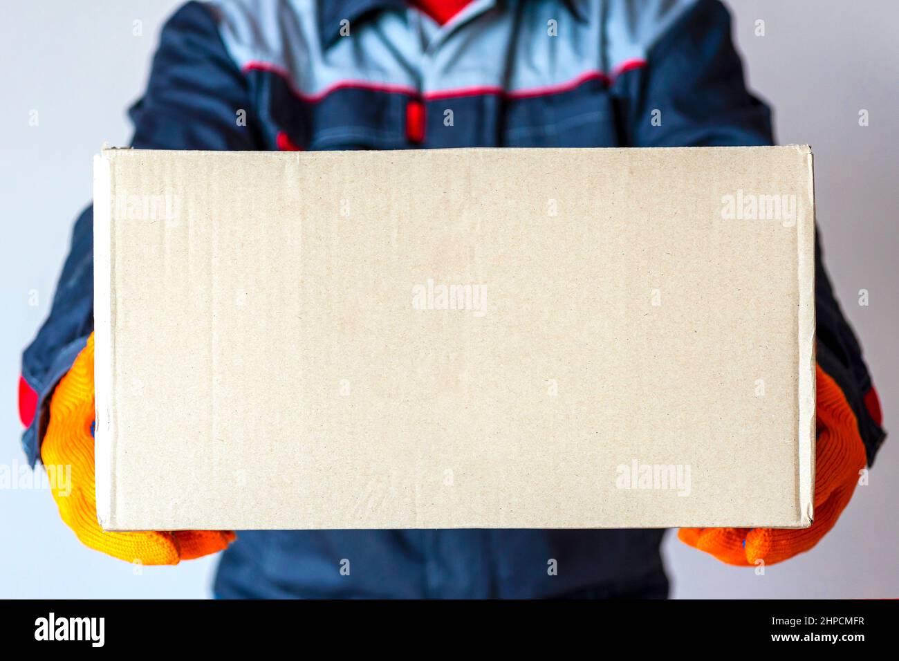 delivery man holding package. Courier holding box. man carrying ...