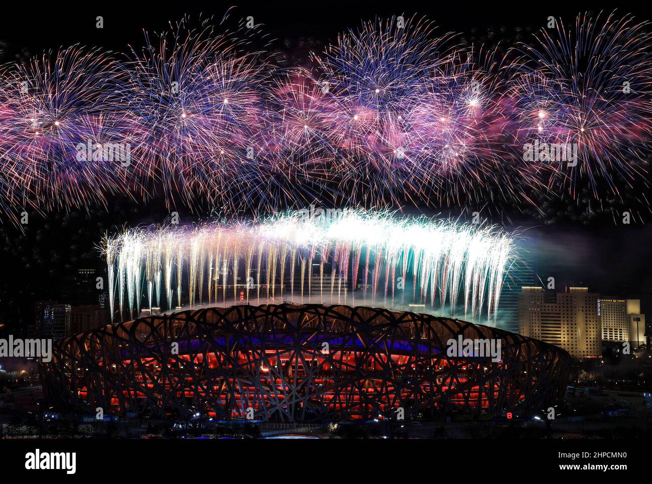 Beijing, China. 20th Feb, 2022. Fireworks illuminate the night sky ...
