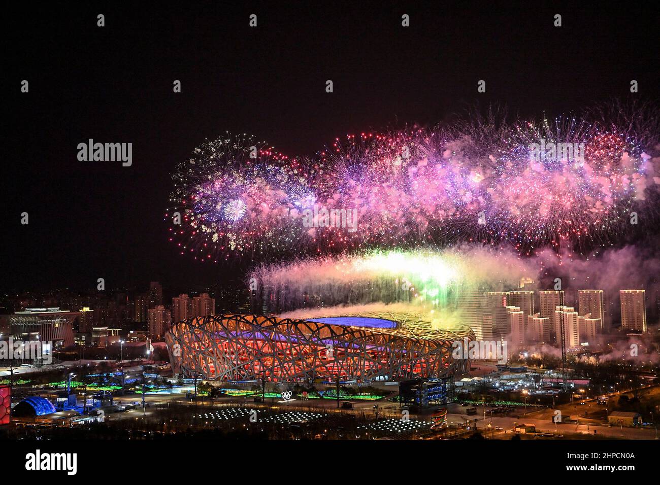 Beijing, China. 20th Feb, 2022. Fireworks illuminate the night sky ...