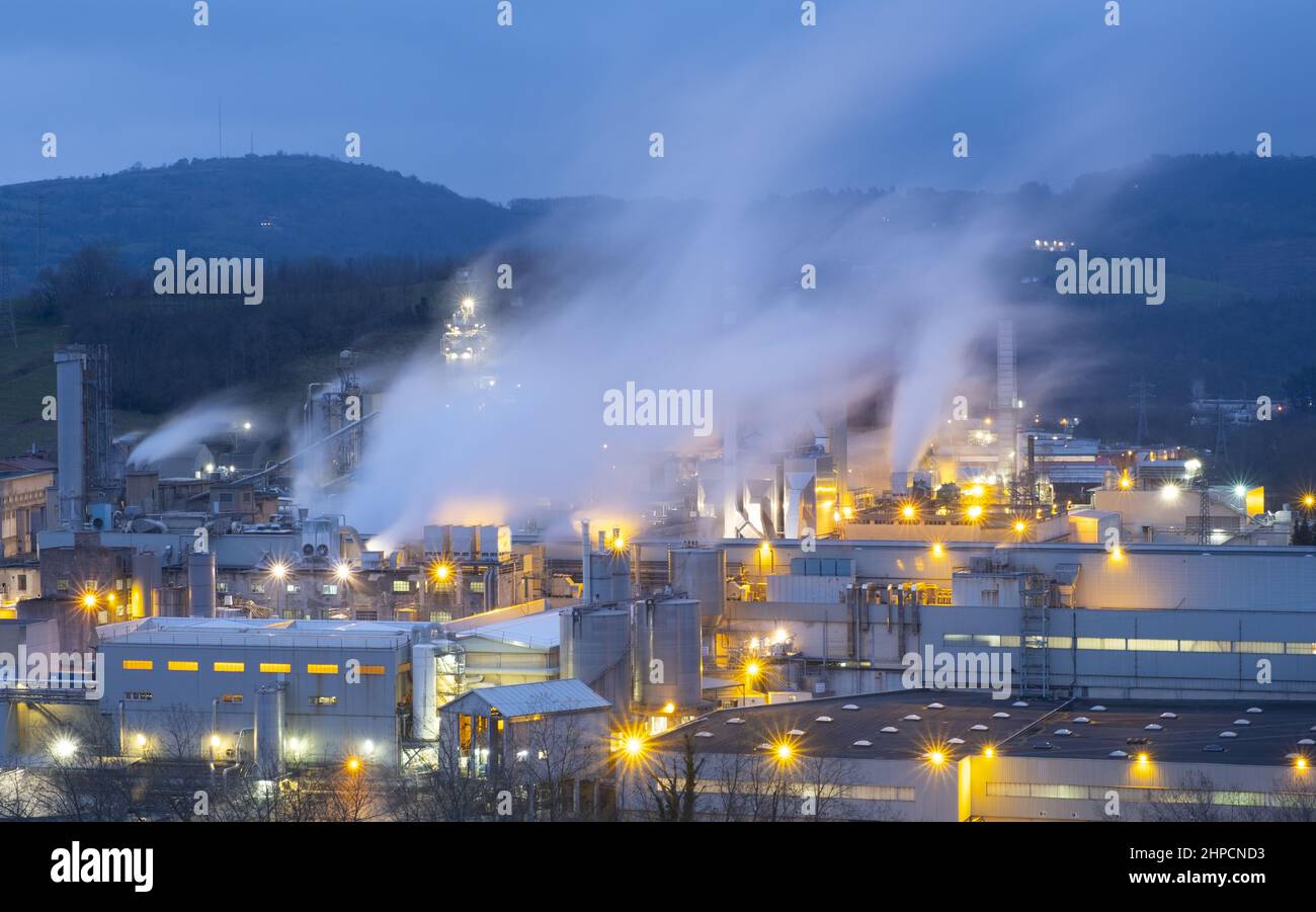 Fumes and pollution in factory chimneys Stock Photo - Alamy