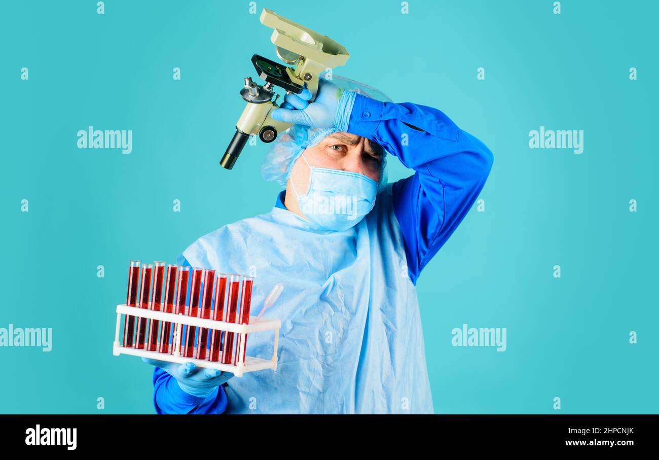 Doctor with blood test tubes and microscope. Science, biology and ...