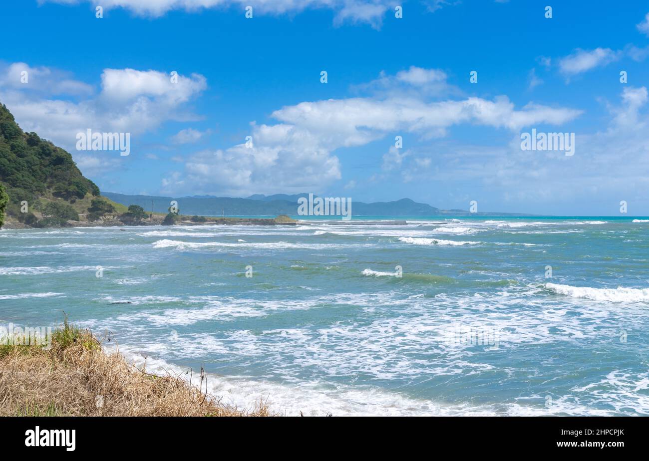 East Coast view of rough sea in windy conditions under blue sky with ...