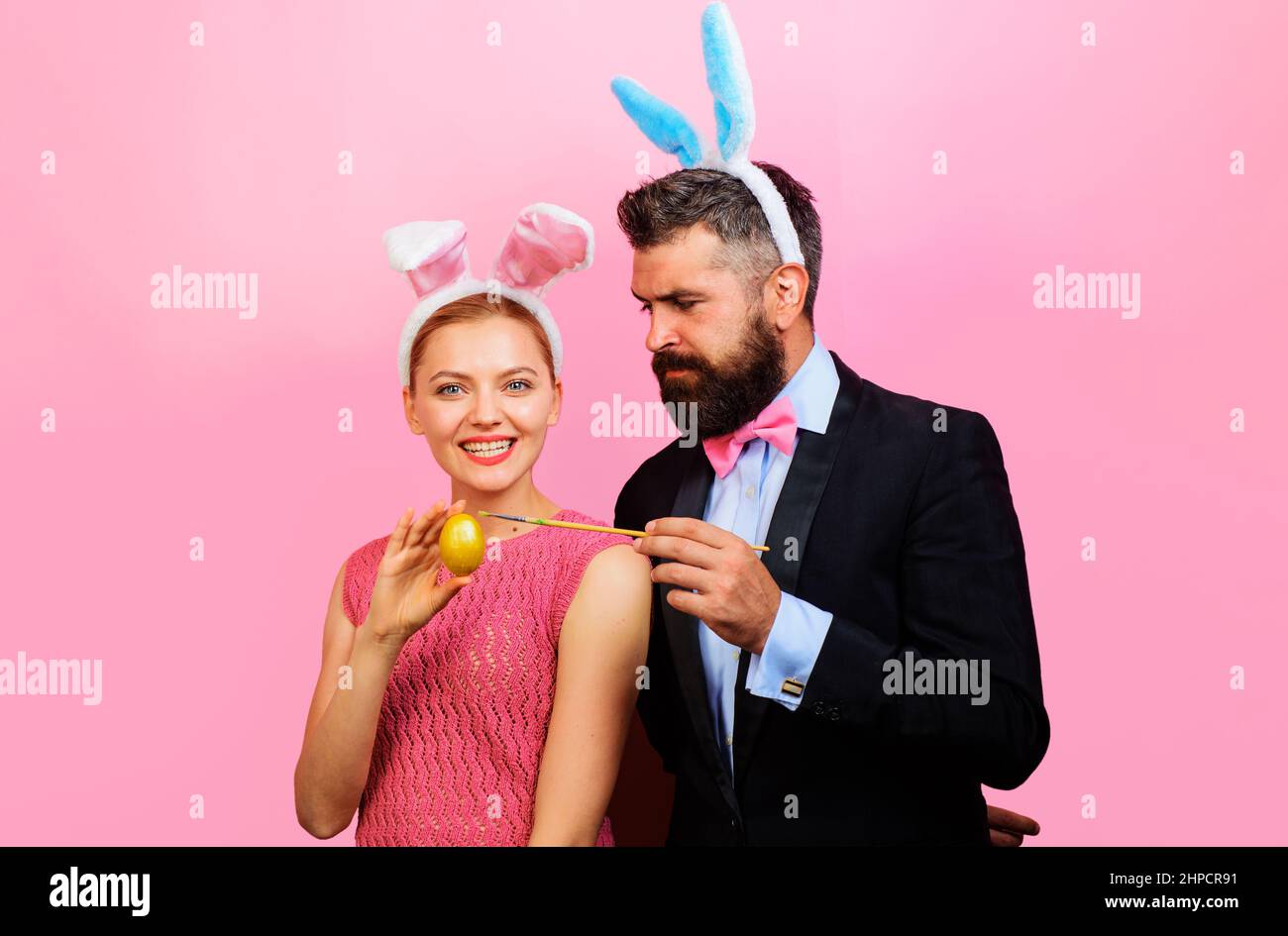 Couple painting eggs for Easter. Rabbit Family celebrate Easter. Happy ...