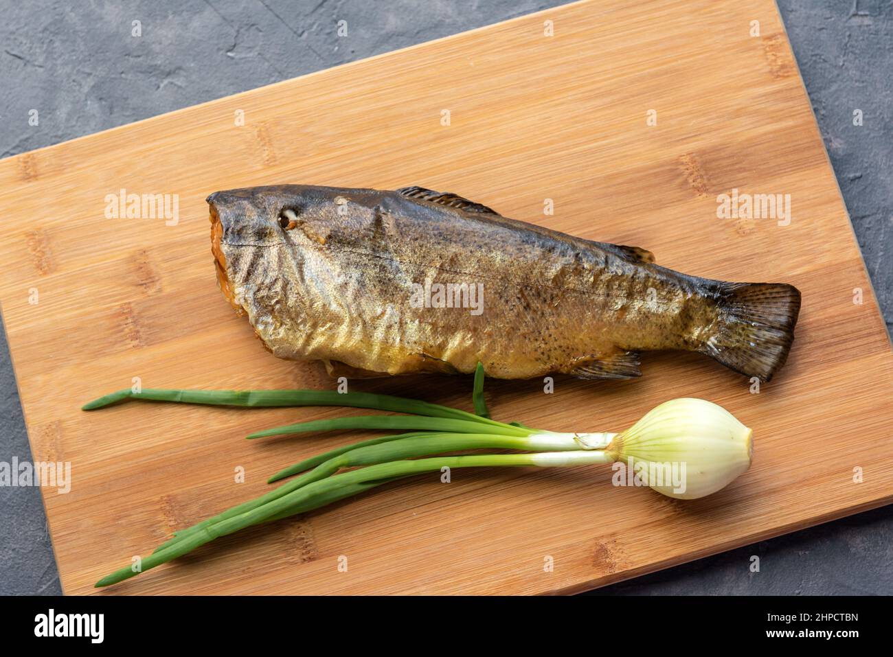 Smoked trout fish on a kitchen board Stock Photo - Alamy