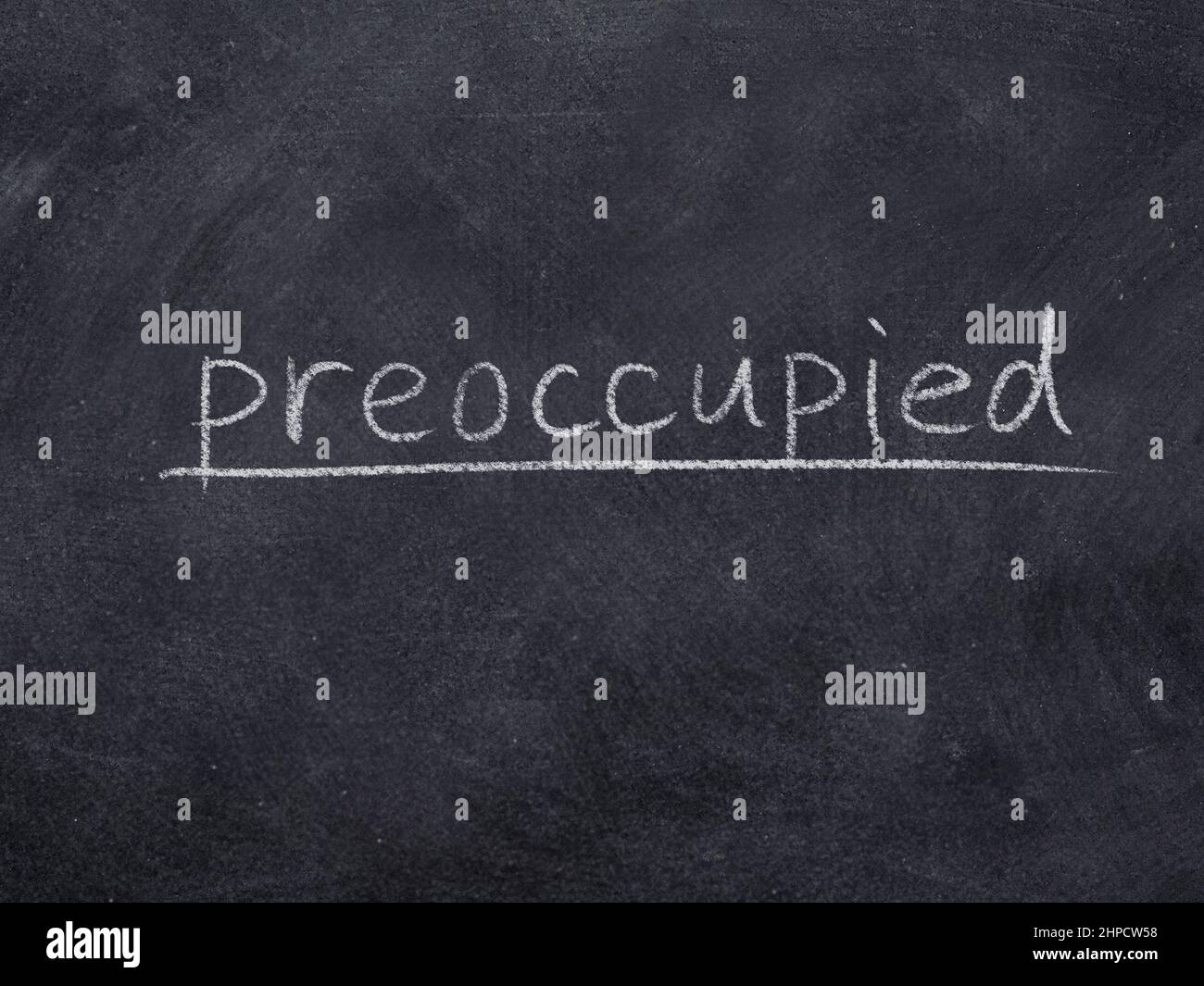 preoccupied concept word on blackboard background Stock Photo - Alamy