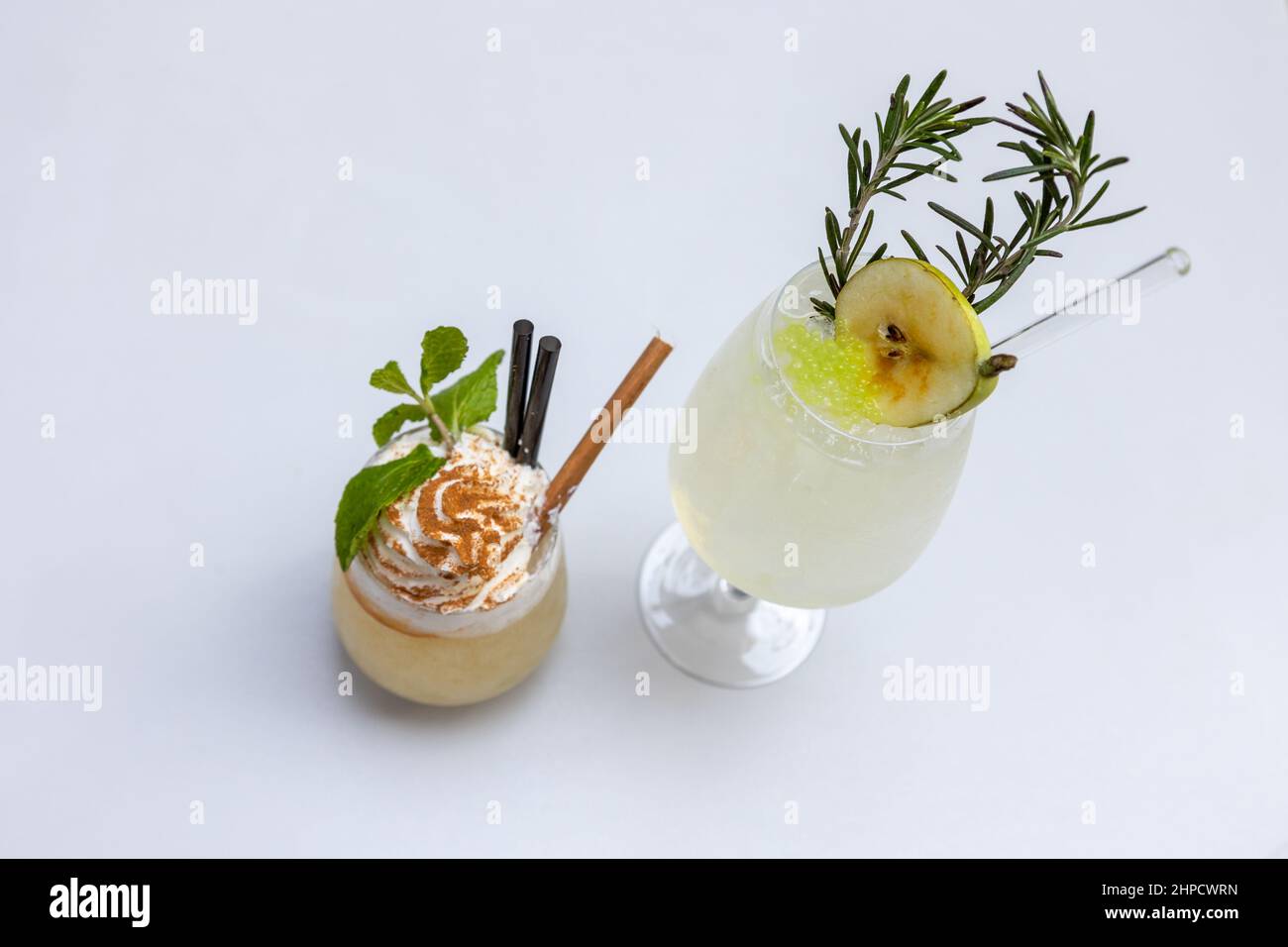 Top view shot of two cocktails with rosemary and cream layer on it ...