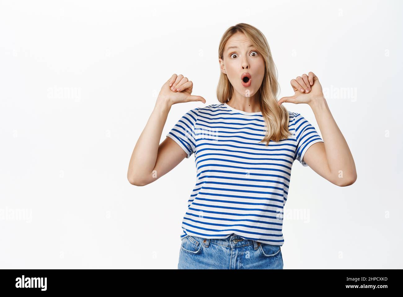 Enthusiastic beautiful woman pointing fingers at herself, self ...