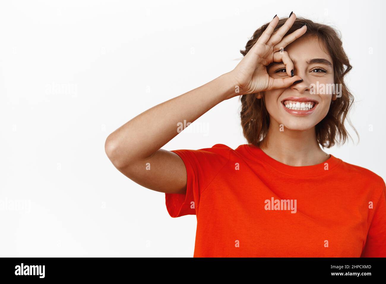 Portrait of happy young smiling woman showing okay, ok sign, approve ...