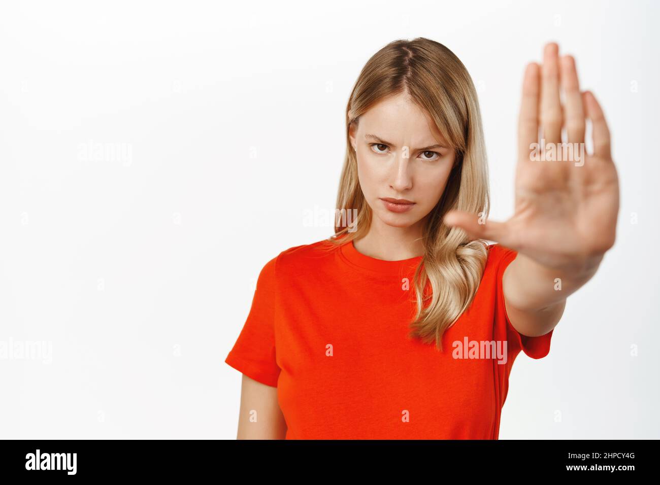 Portrait of serious young blond woman say stop, showing taboo, block ...