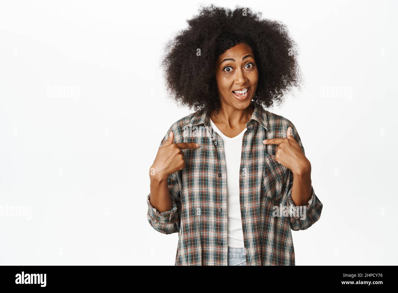 Cute silly african girl pointing at herself and smiling coy, asking for ...