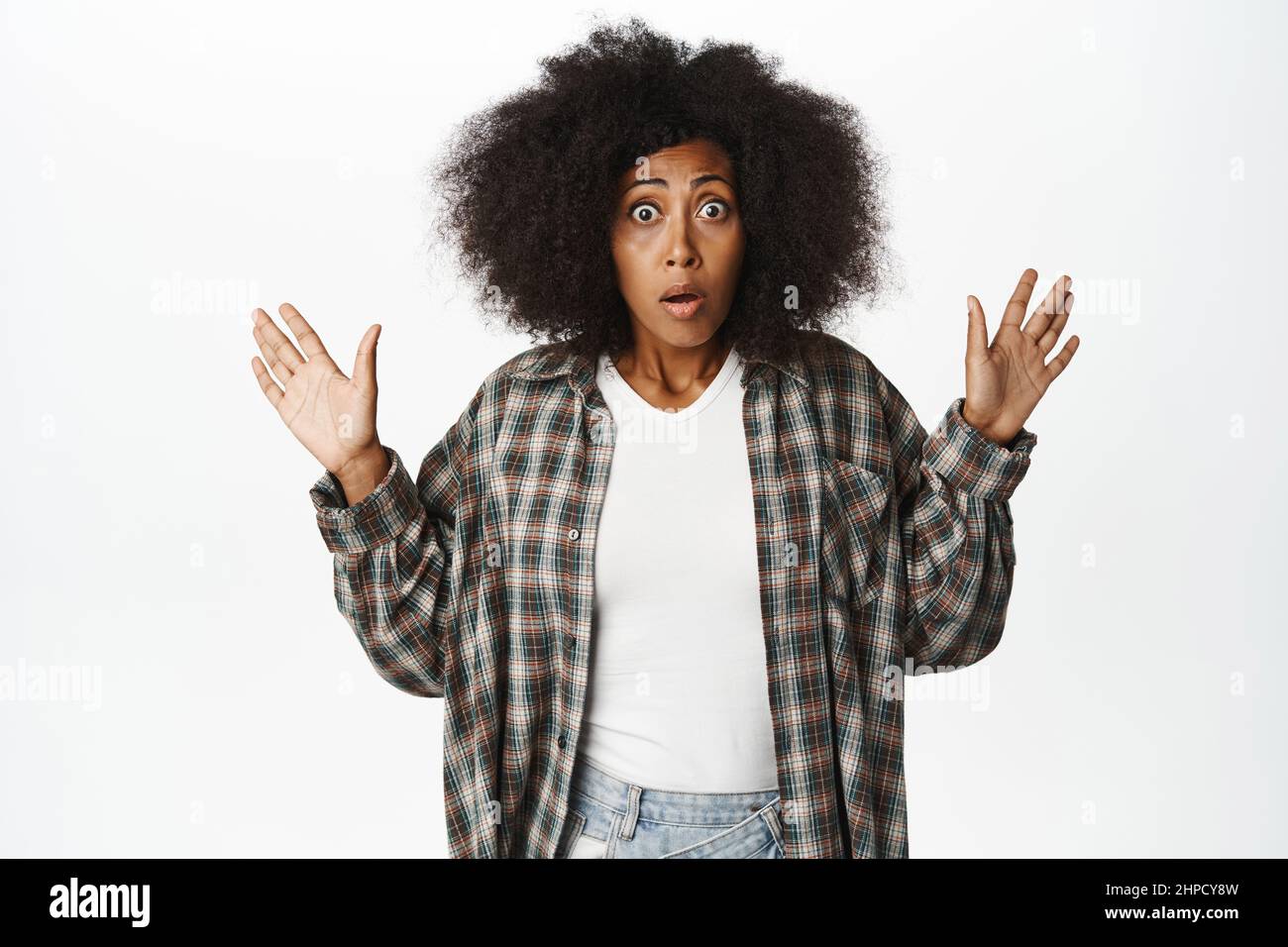 Portrait of shocked african woman drop smth down, raising hands up and ...