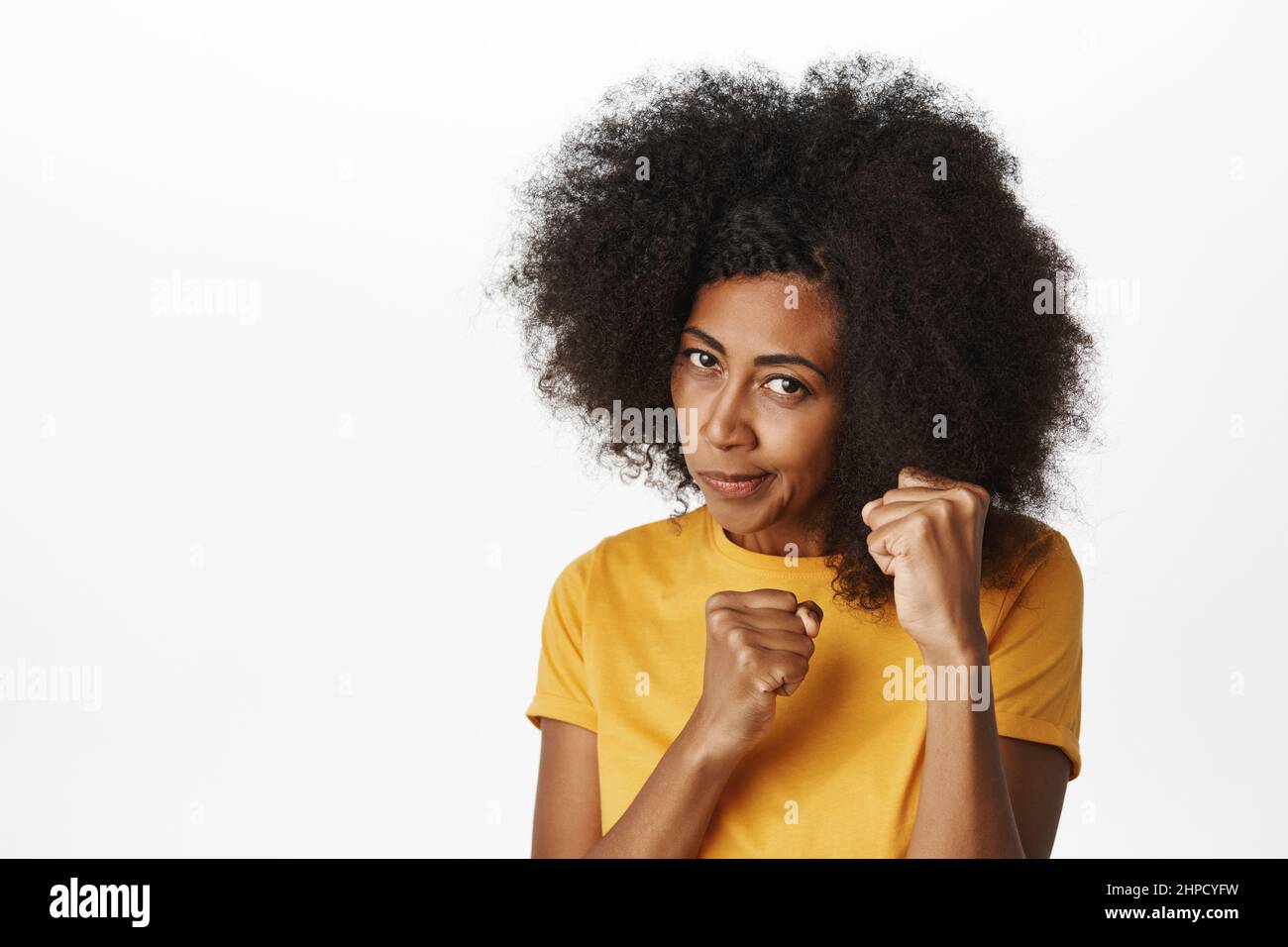 Ready to fight. Sassy african american lady showing punch, fists ...
