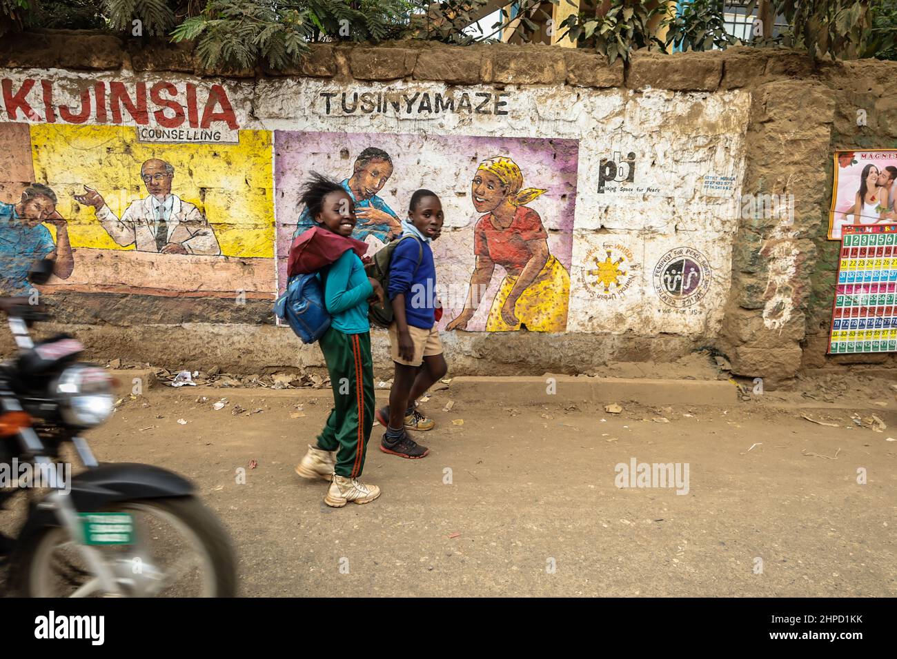 Pupils walk home from school past the streets in Kibera Slums. Inside ...
