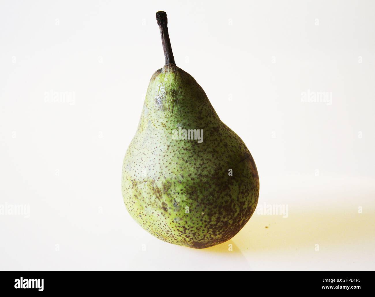 A fresh and ripe English pear on a white background Stock Photo - Alamy