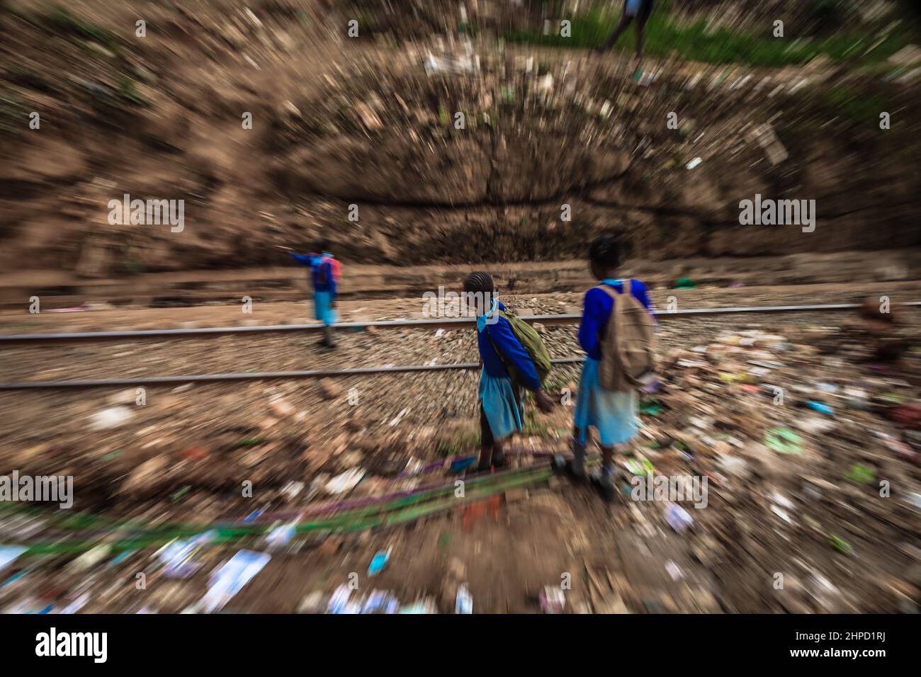 Pupils walk past the Nairobi Railway line headed back home from School ...