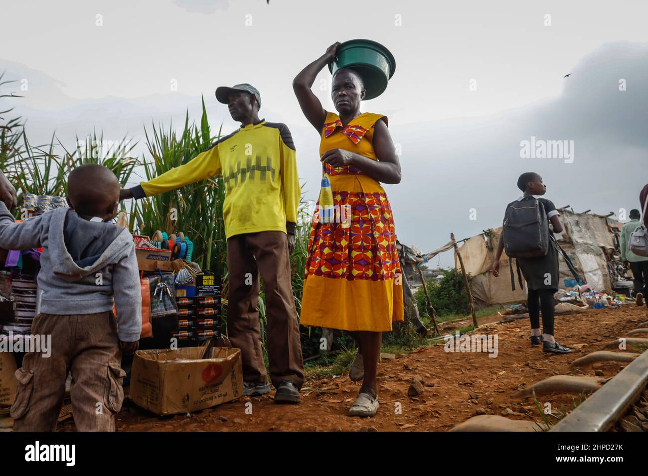 Local residents focus on their day-to-day business activities along the ...