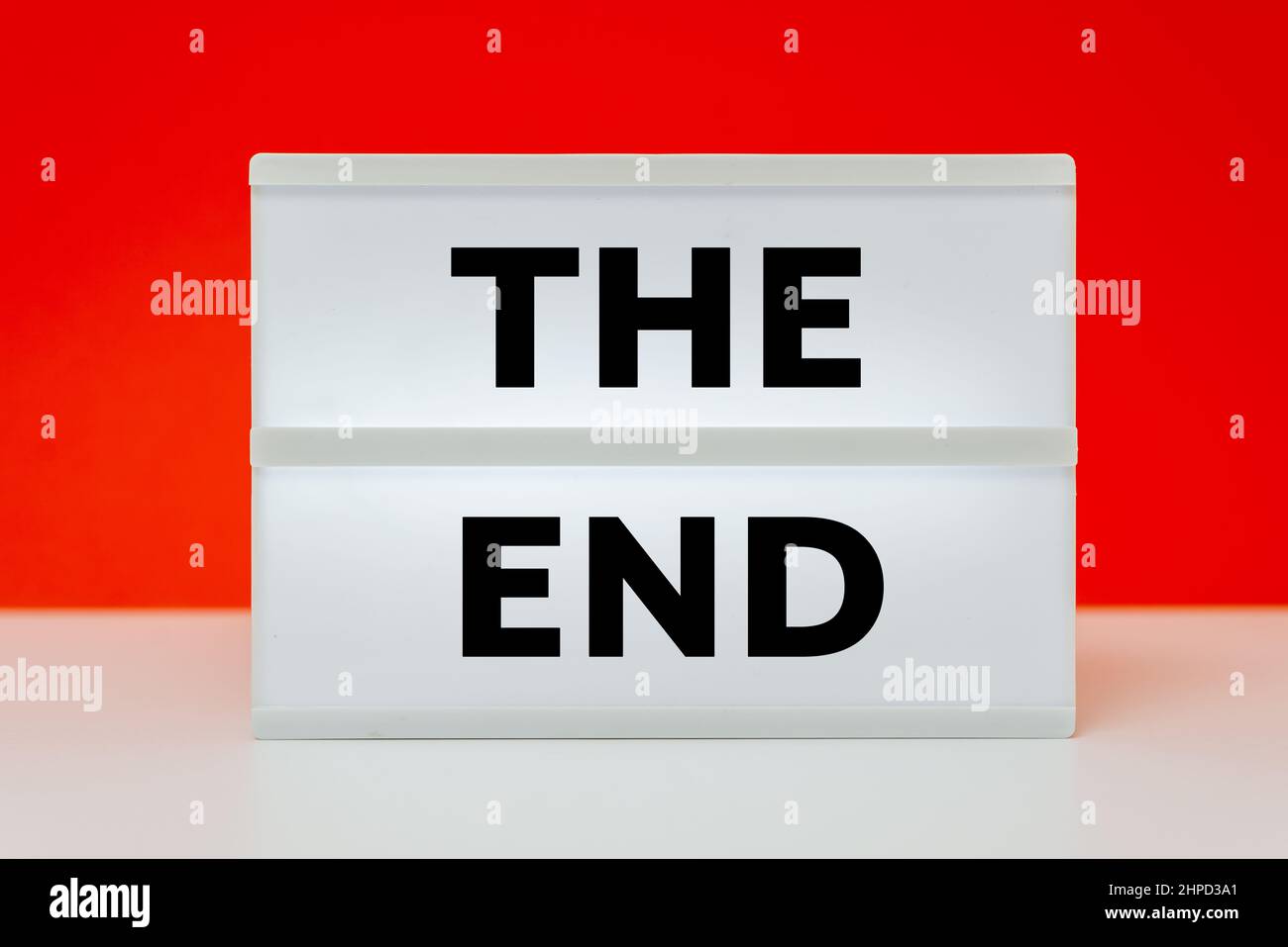 A signboard with the message The End on a red wall background Stock ...