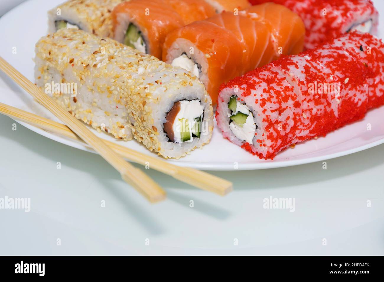 Sushi rolls wrapped in nori. Sushi sticks next to the rolls ...