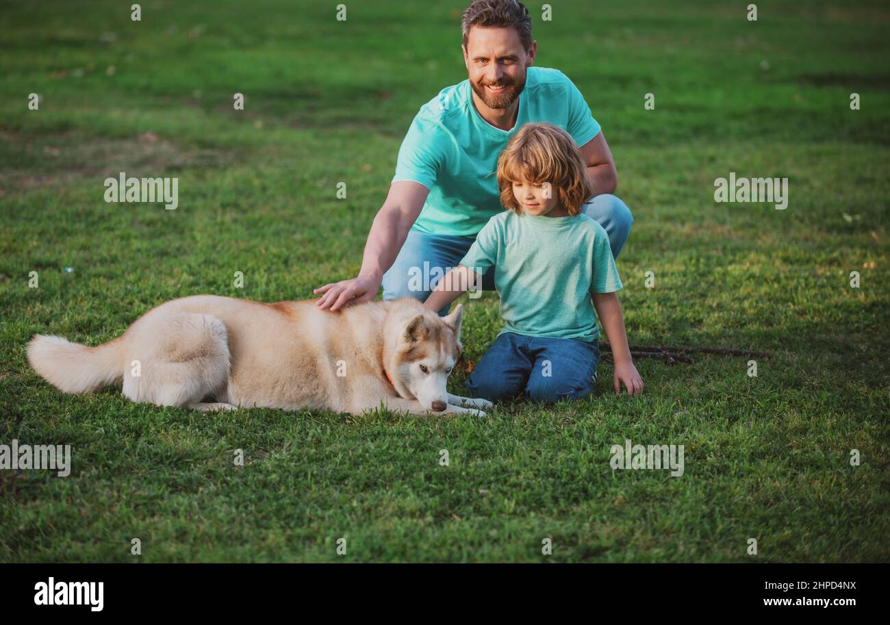 Father and son with dog on nature. Dad and child with pet dog having ...