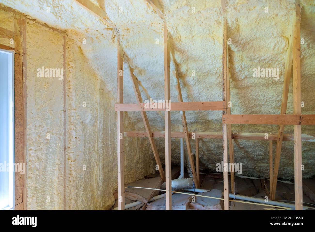 Mineral glass wool in a wooden frame on a inclined wall near the wooden ...
