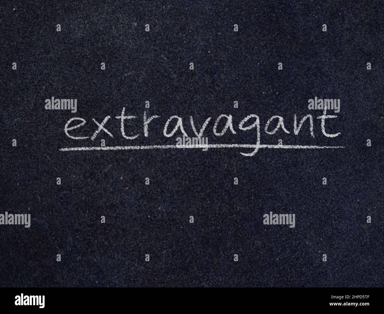 extravagant concept word on blackboard background Stock Photo - Alamy