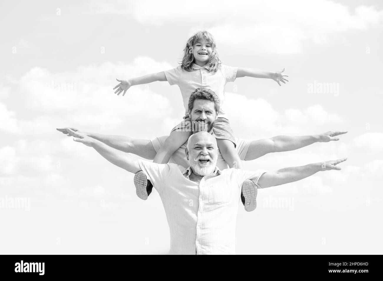 Fathers day. Father and son with grandfather raising hands or open arms ...