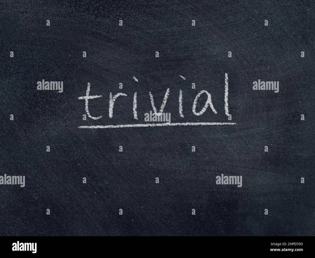 trivial concept word on blackboard background Stock Photo - Alamy