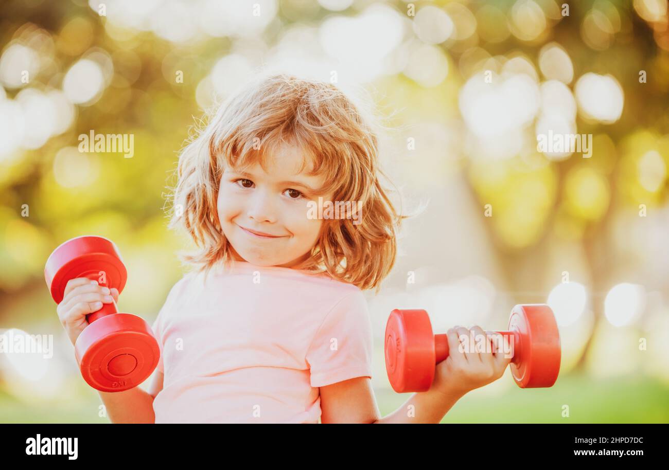 Sport child with dumbbell. Kids sport. Boy exercising in park. Active ...