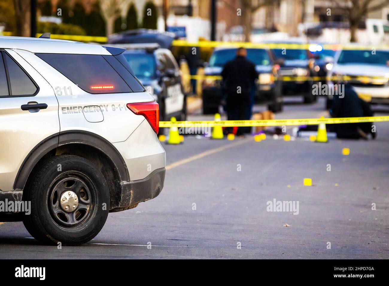 Police car with emergency lights on road with caution tape in the back ...