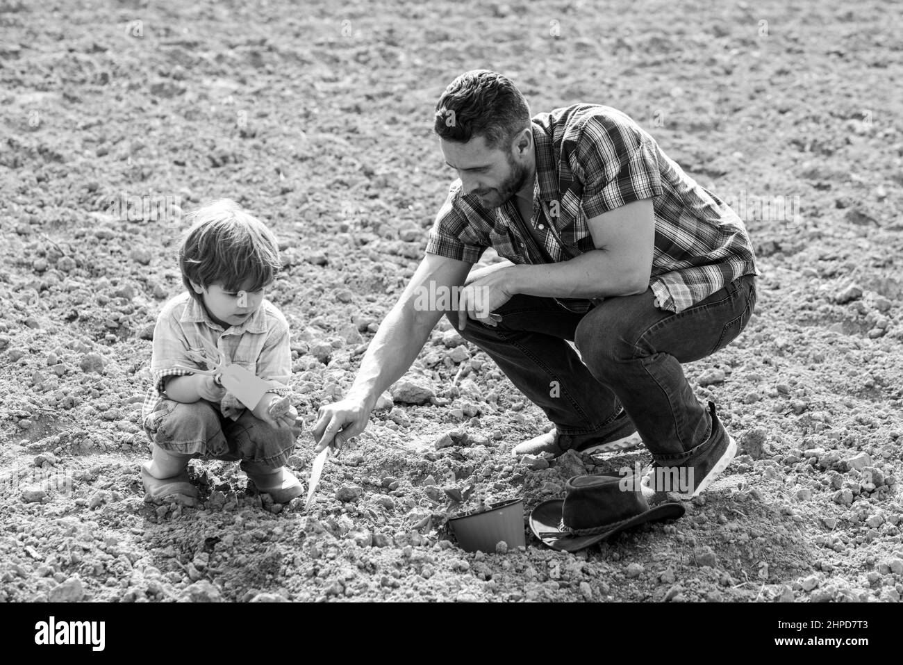 Father and son planting. Growing plants. Spring garden. Dad teaching ...
