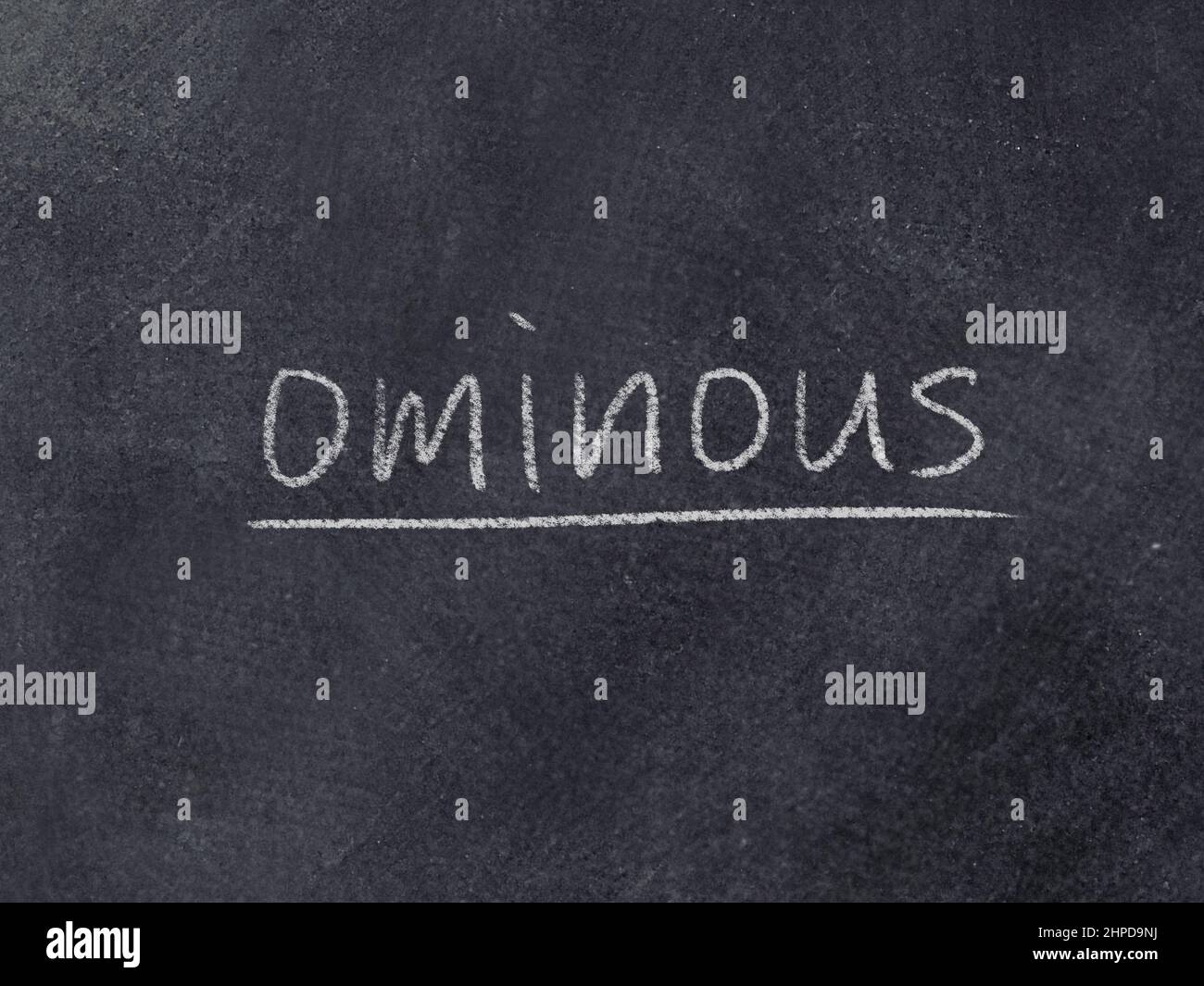 ominous concept word on blackboard background Stock Photo - Alamy