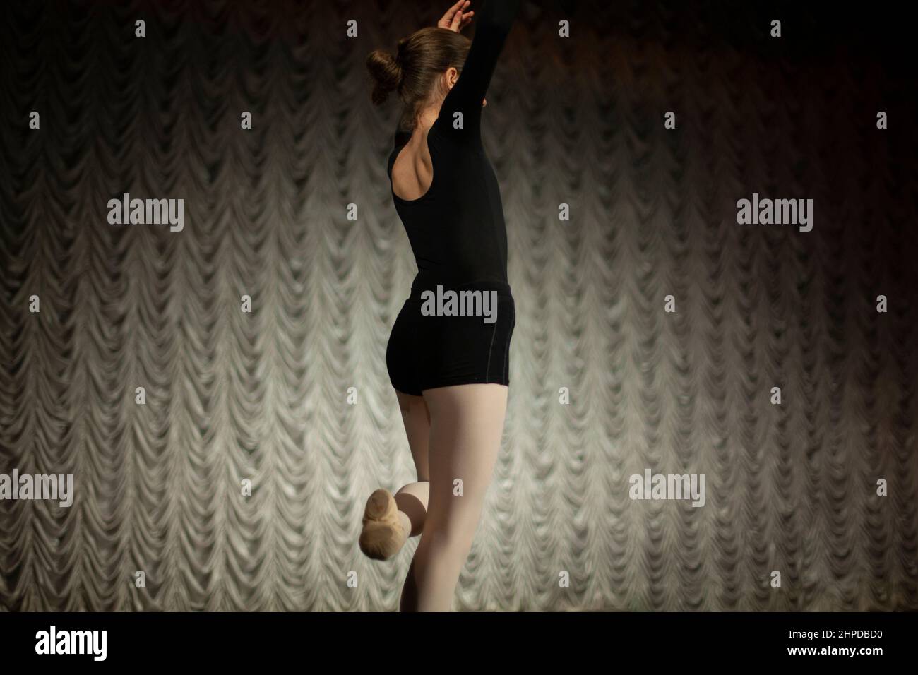 Dance student. A child dances ballet. Dance lesson on stage. The girl ...