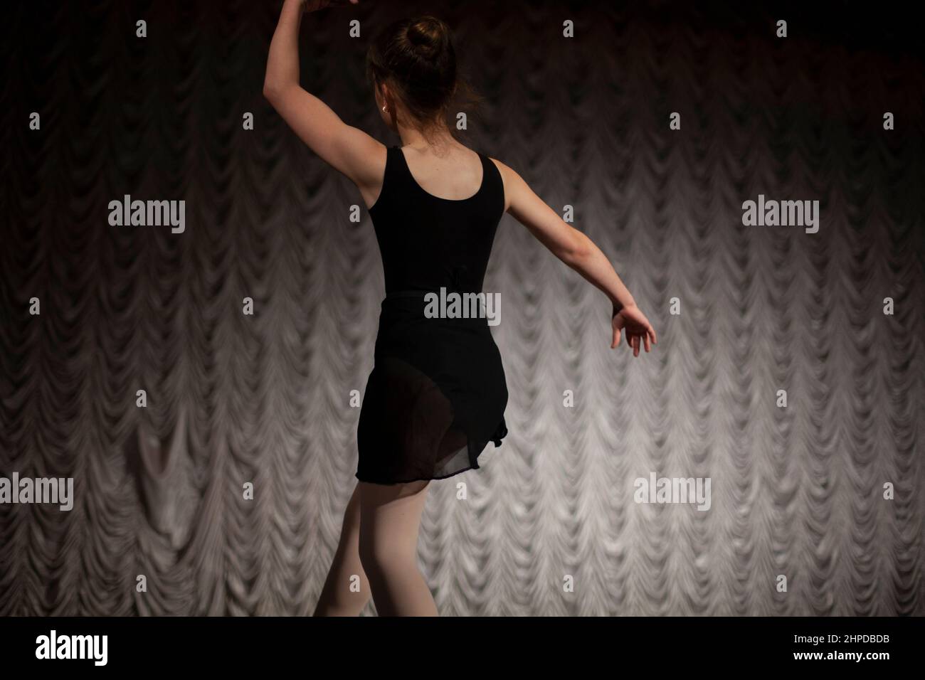 Dance student. A child dances ballet. Dance lesson on stage. The girl ...