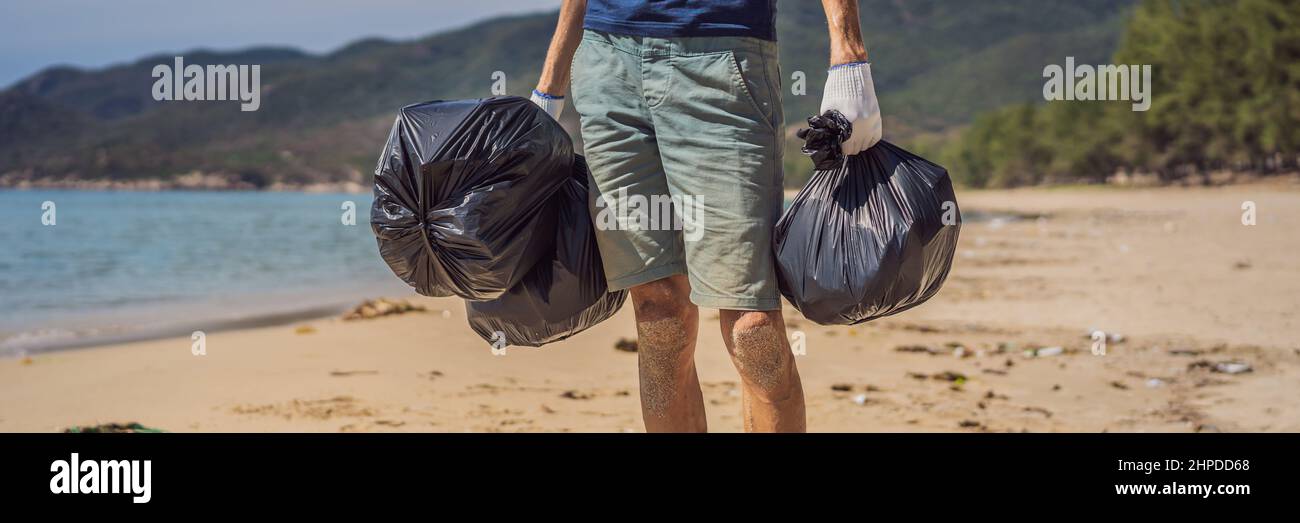 Man in gloves pick up plastic bags that pollute sea. Problem of spilled ...