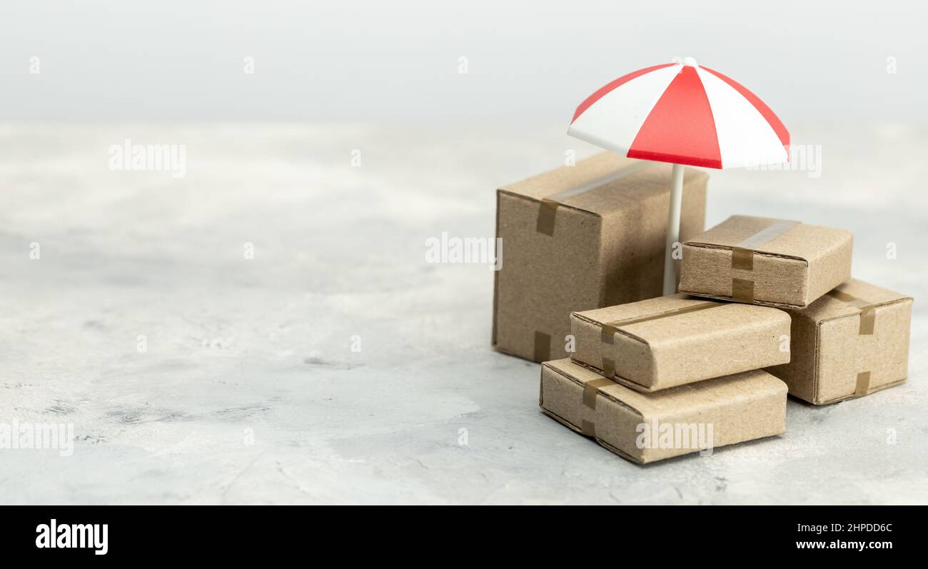 Delivery insurance. Cardboard boxes protected by an umbrella. Template ...