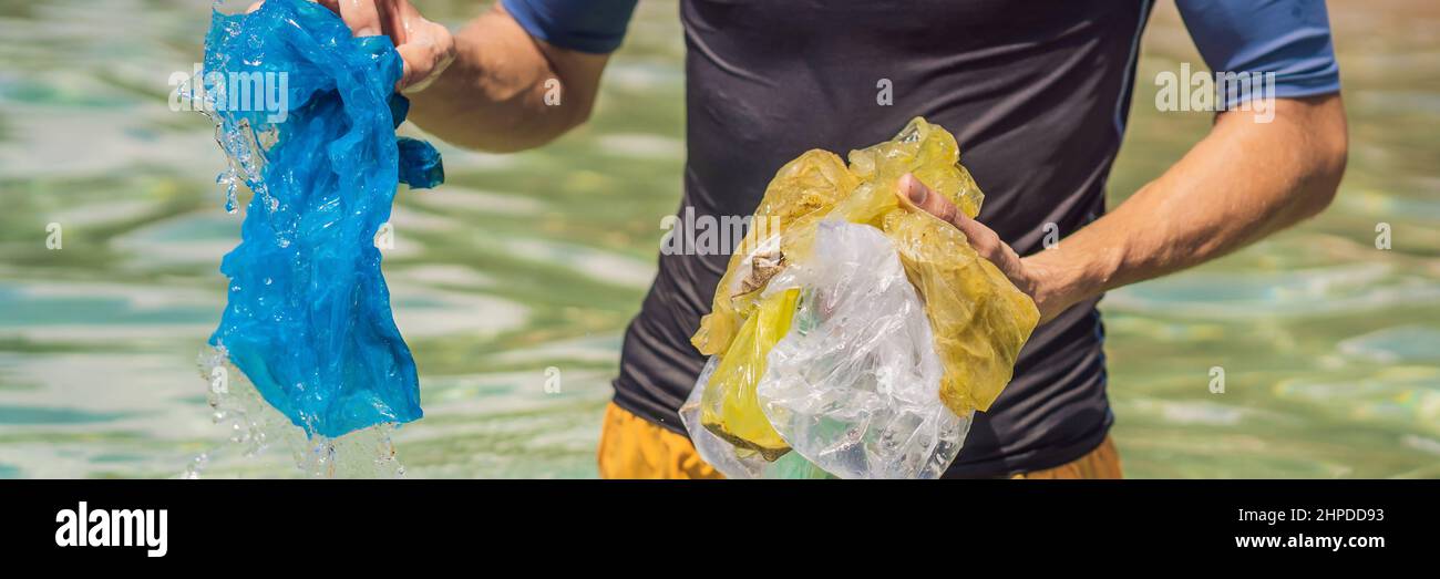 Man collects packages from the beautiful turquoise sea. Paradise beach ...